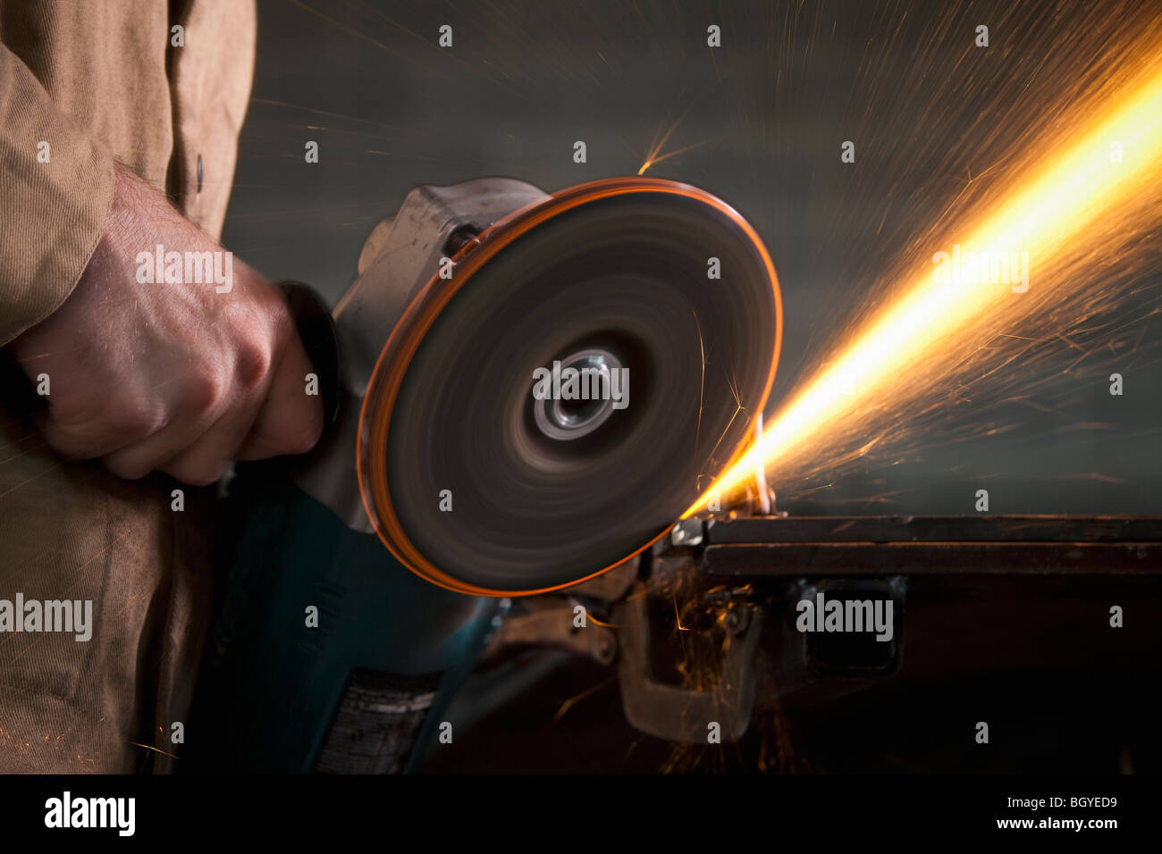 Steel grinder working in metal shop Stock Photo - Alamy