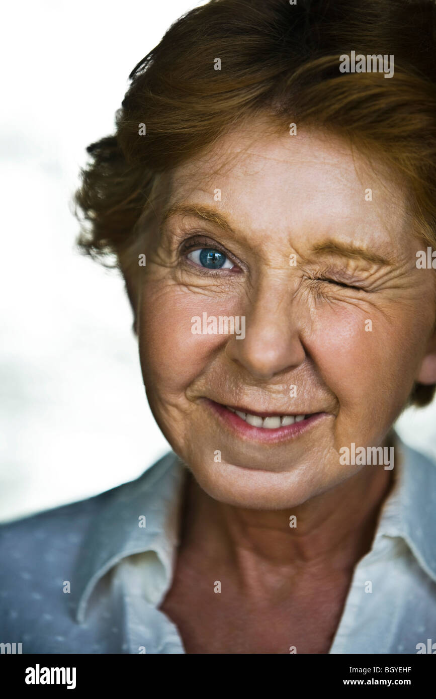 Senior woman winking, portrait Stock Photo - Alamy