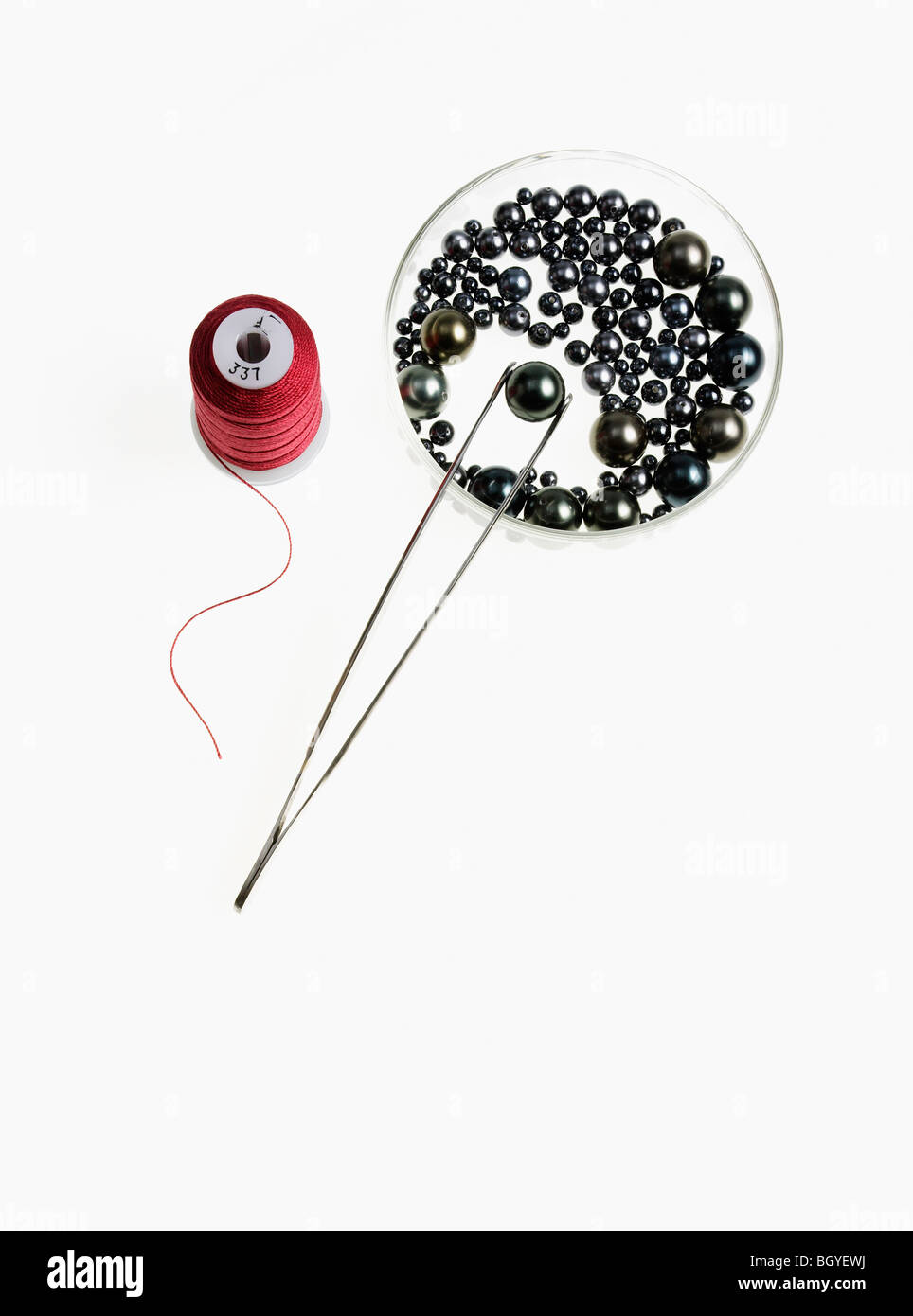 Tweezers thread and pearls Stock Photo - Alamy