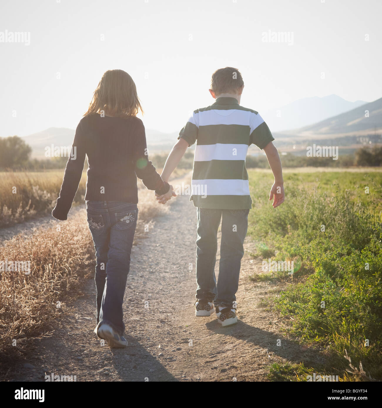 Young children walking on path Stock Photo - Alamy