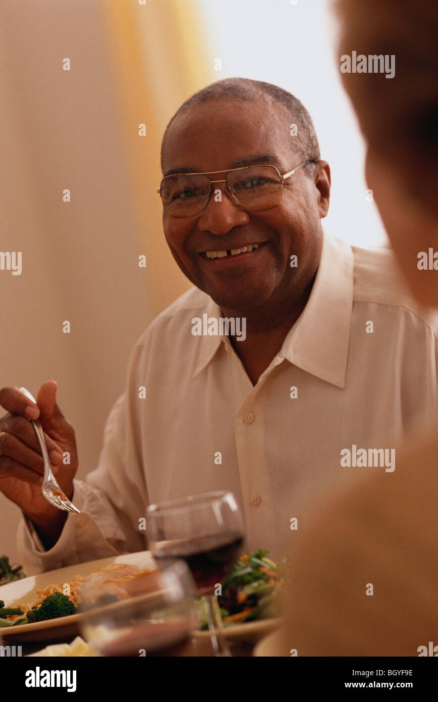 Senior man eating meal Stock Photo - Alamy