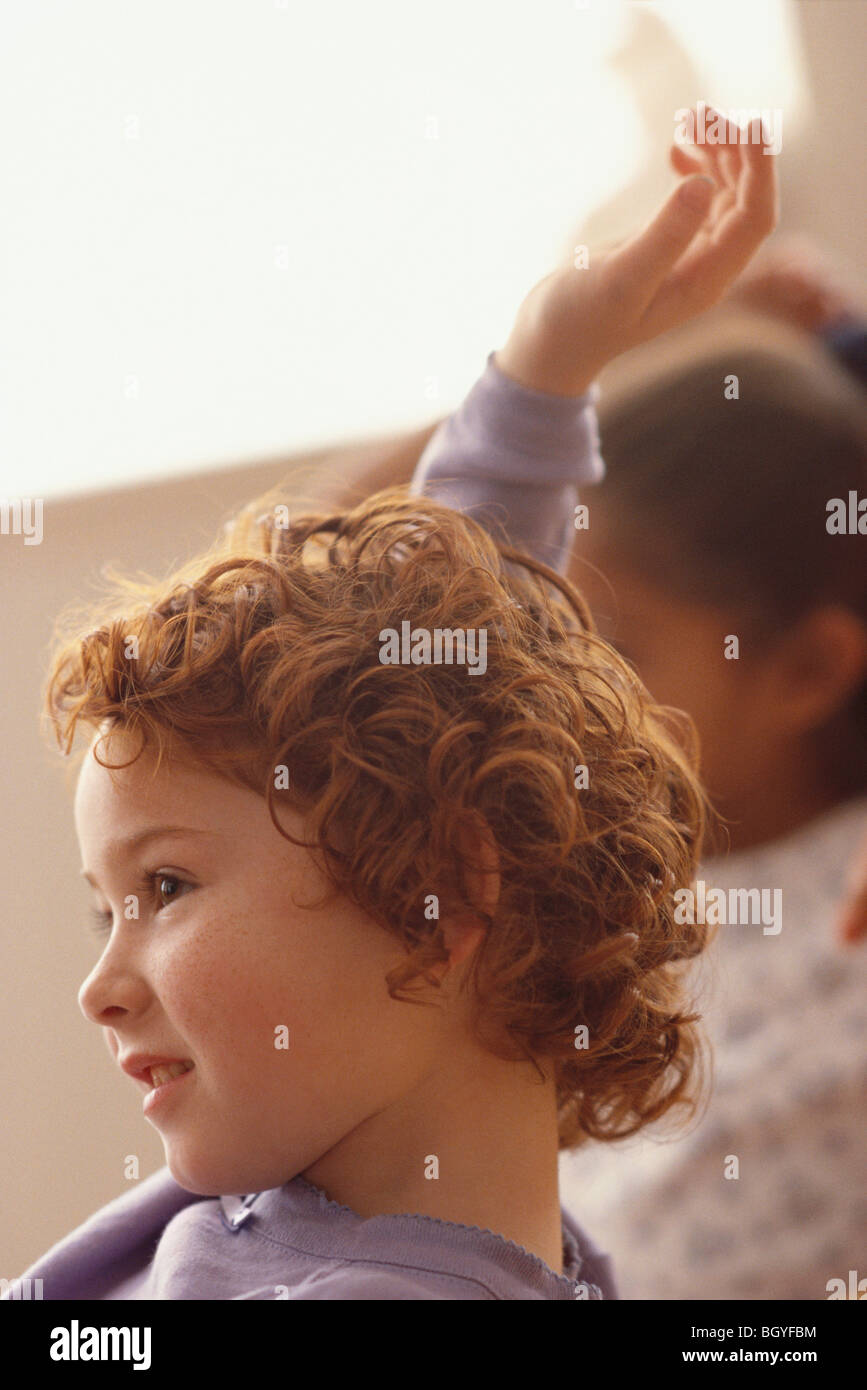 Girl raising hand Stock Photo - Alamy