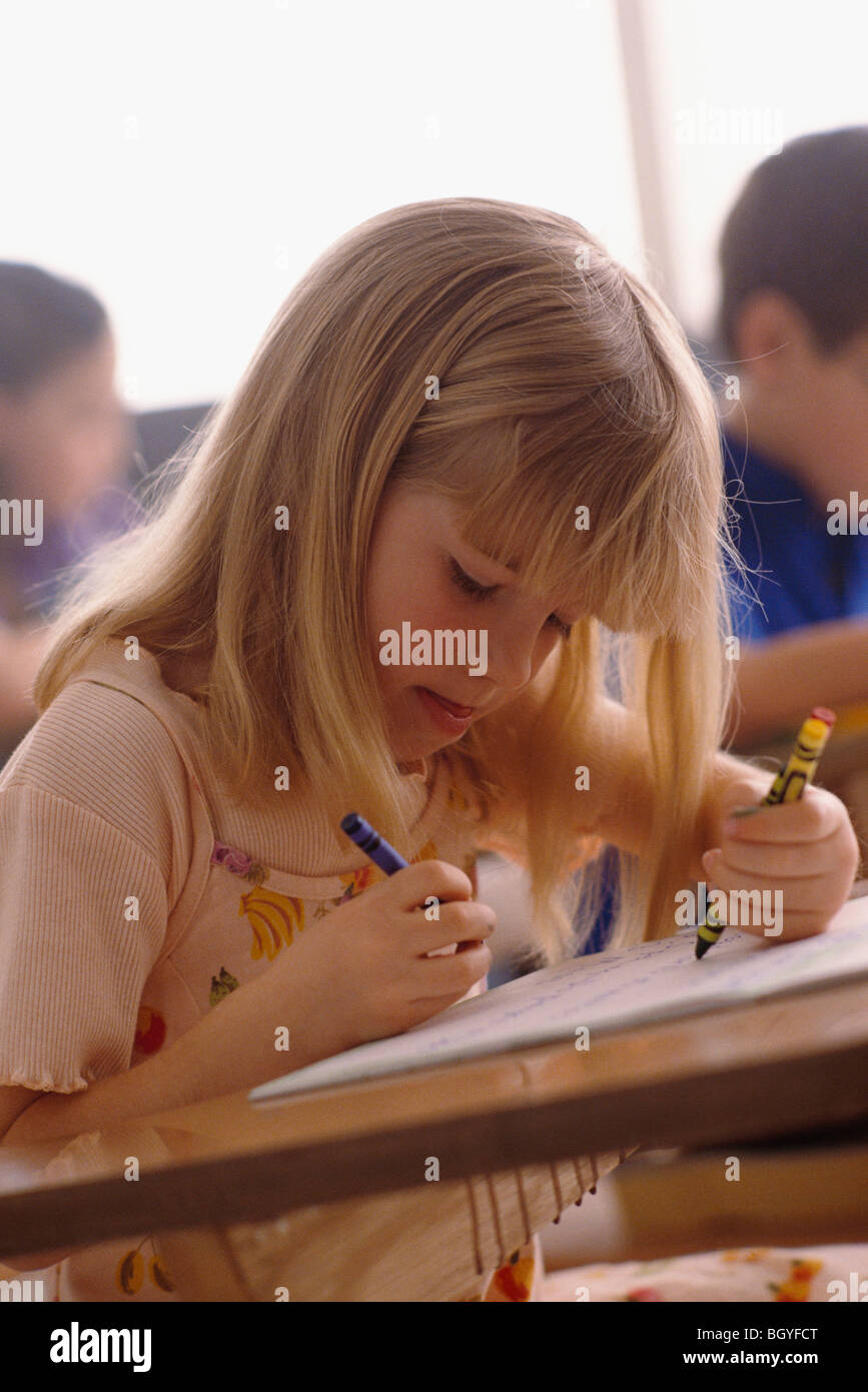 Girl drawing with crayons Stock Photo - Alamy
