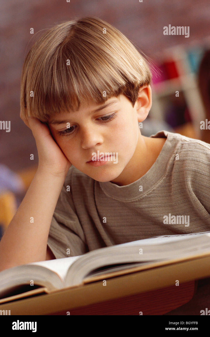 Student reading in classroom Stock Photo - Alamy