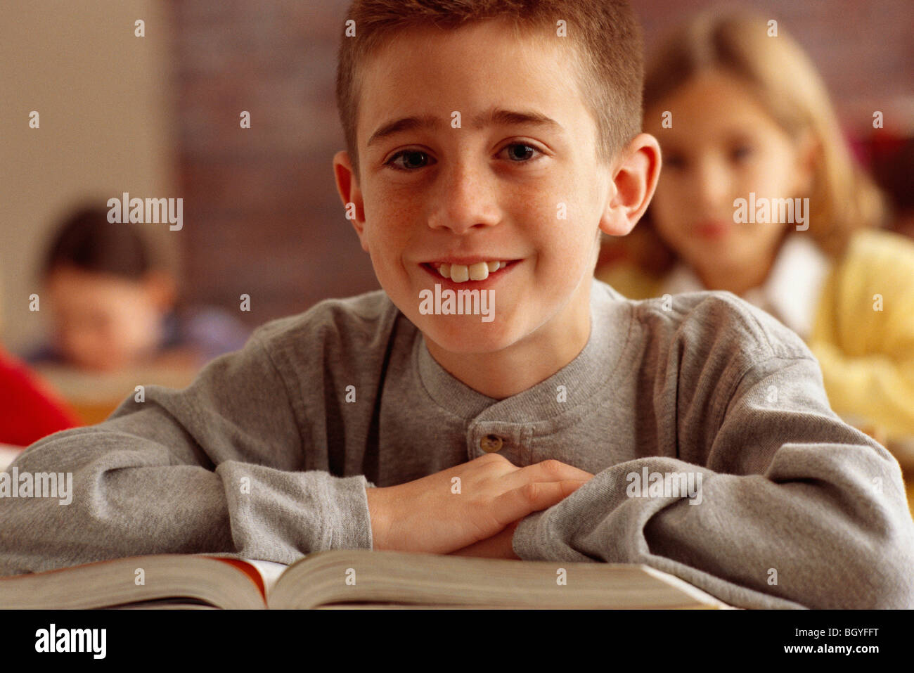 Student sitting at desk in classroom Stock Photo - Alamy