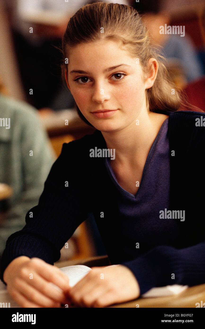Student sitting at desk in classroom Stock Photo - Alamy
