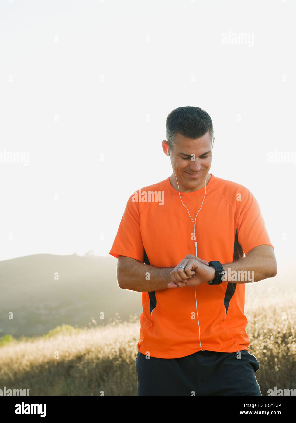 Man looking at watch Stock Photo - Alamy