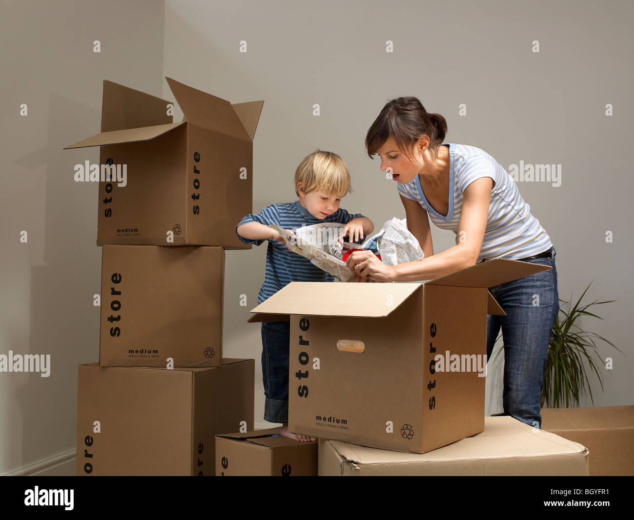 Mother and son unpacking moving boxes Stock Photo - Alamy