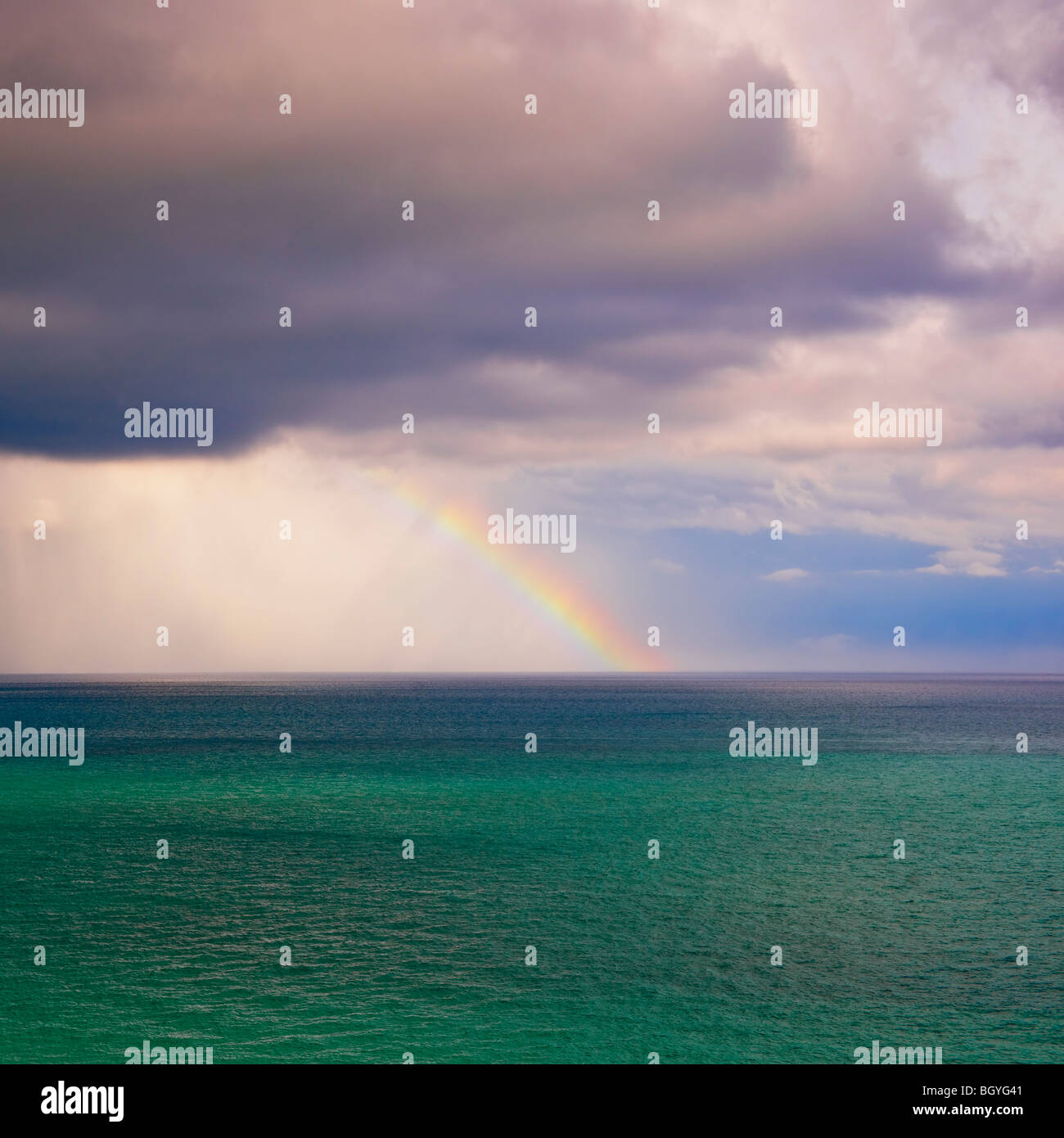 Rainbow over ocean Stock Photo - Alamy