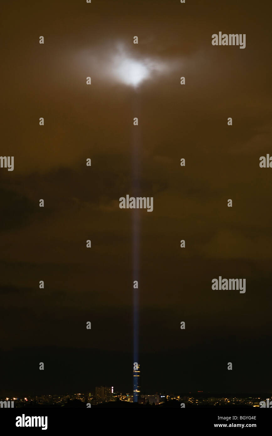 Spotlight reflected upon cloud illuminating night sky above city Stock ...