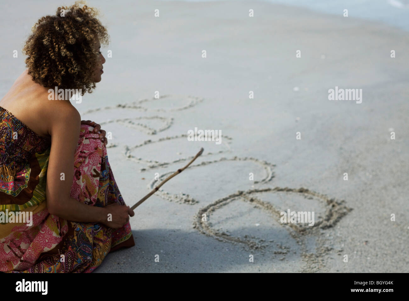 Woman writes in sand word hi-res stock photography and images - Alamy