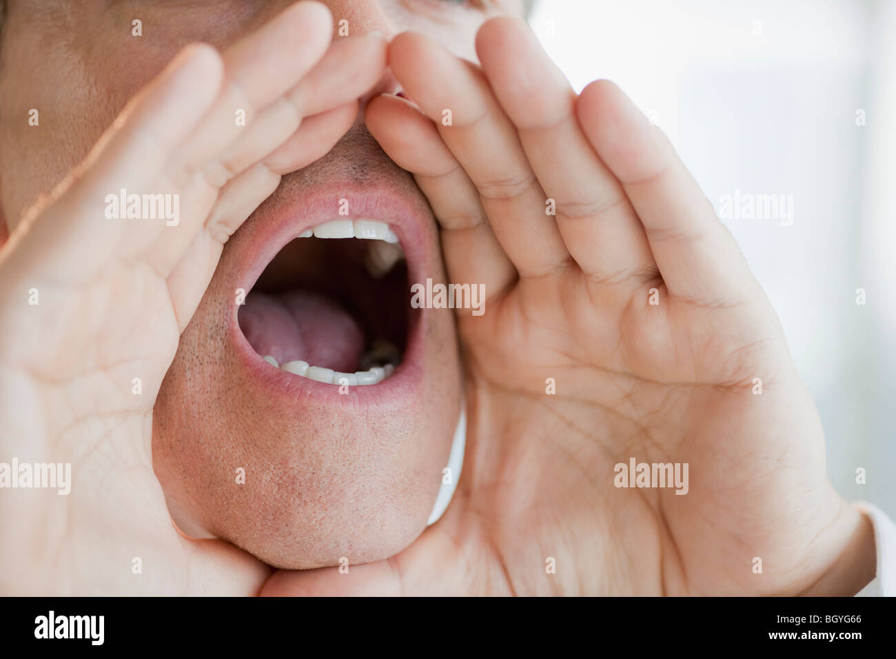 Yell hands cupping mouth hi-res stock photography and images - Alamy