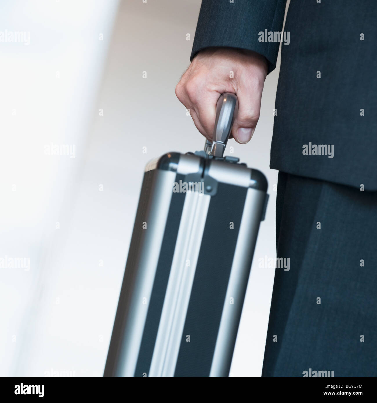 Businessman holding briefcase Stock Photo - Alamy