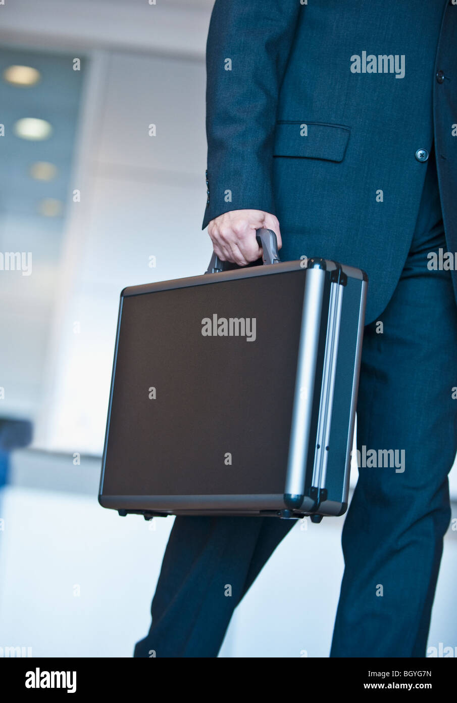 Businessman holding briefcase Stock Photo - Alamy