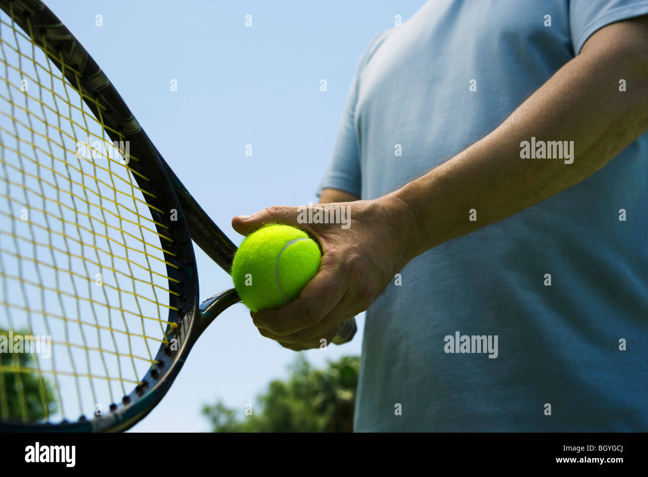 Tennis player preparing to serve, cropped Stock Photo - Alamy