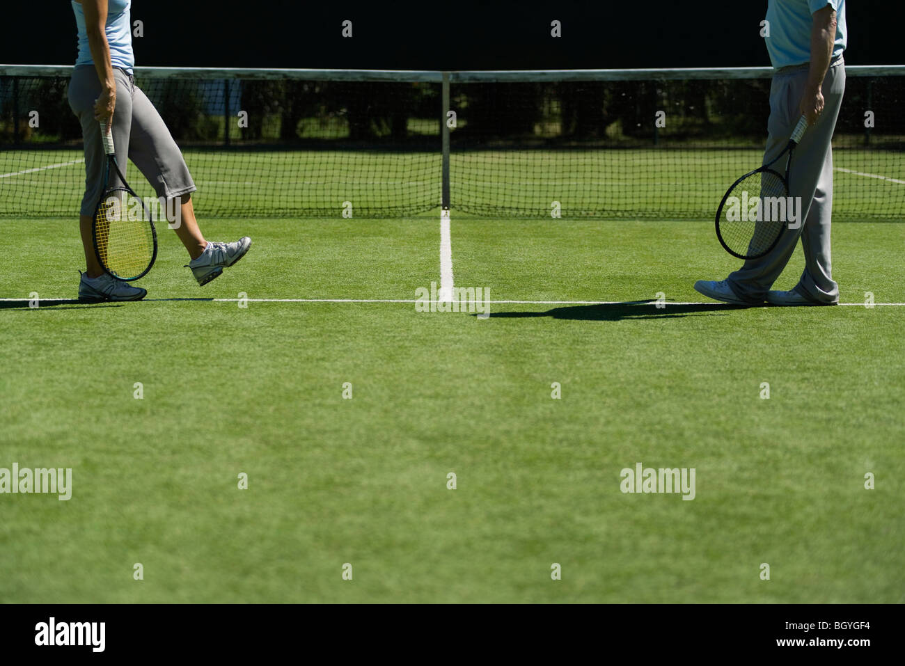 Tennis players walking across court to meet, cropped Stock Photo - Alamy