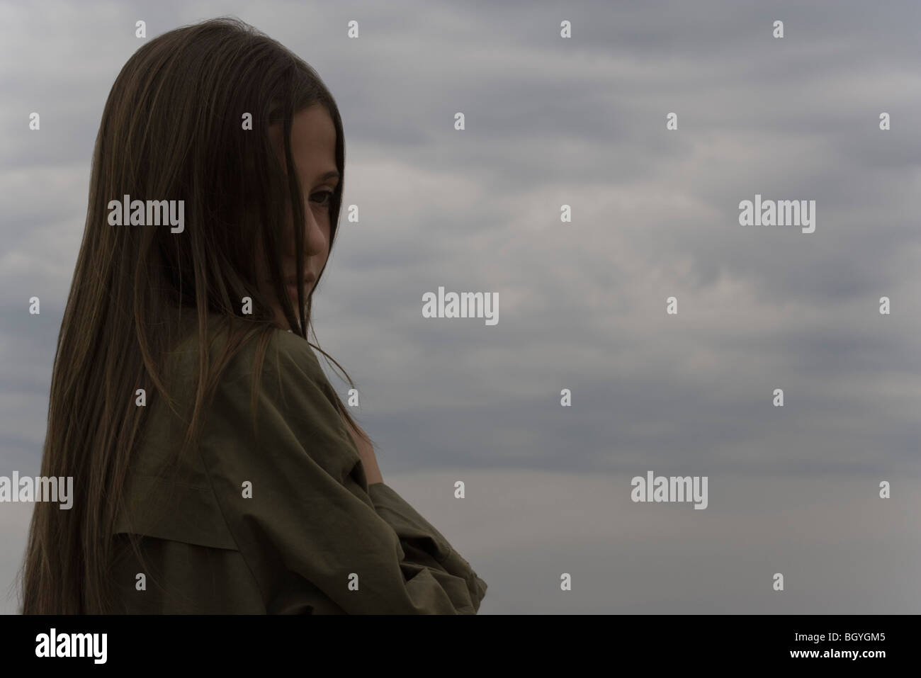 Sad girl looking over shoulder hi-res stock photography and images - Alamy