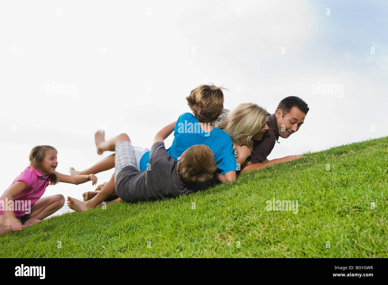 Family playing on grass Stock Photo - Alamy