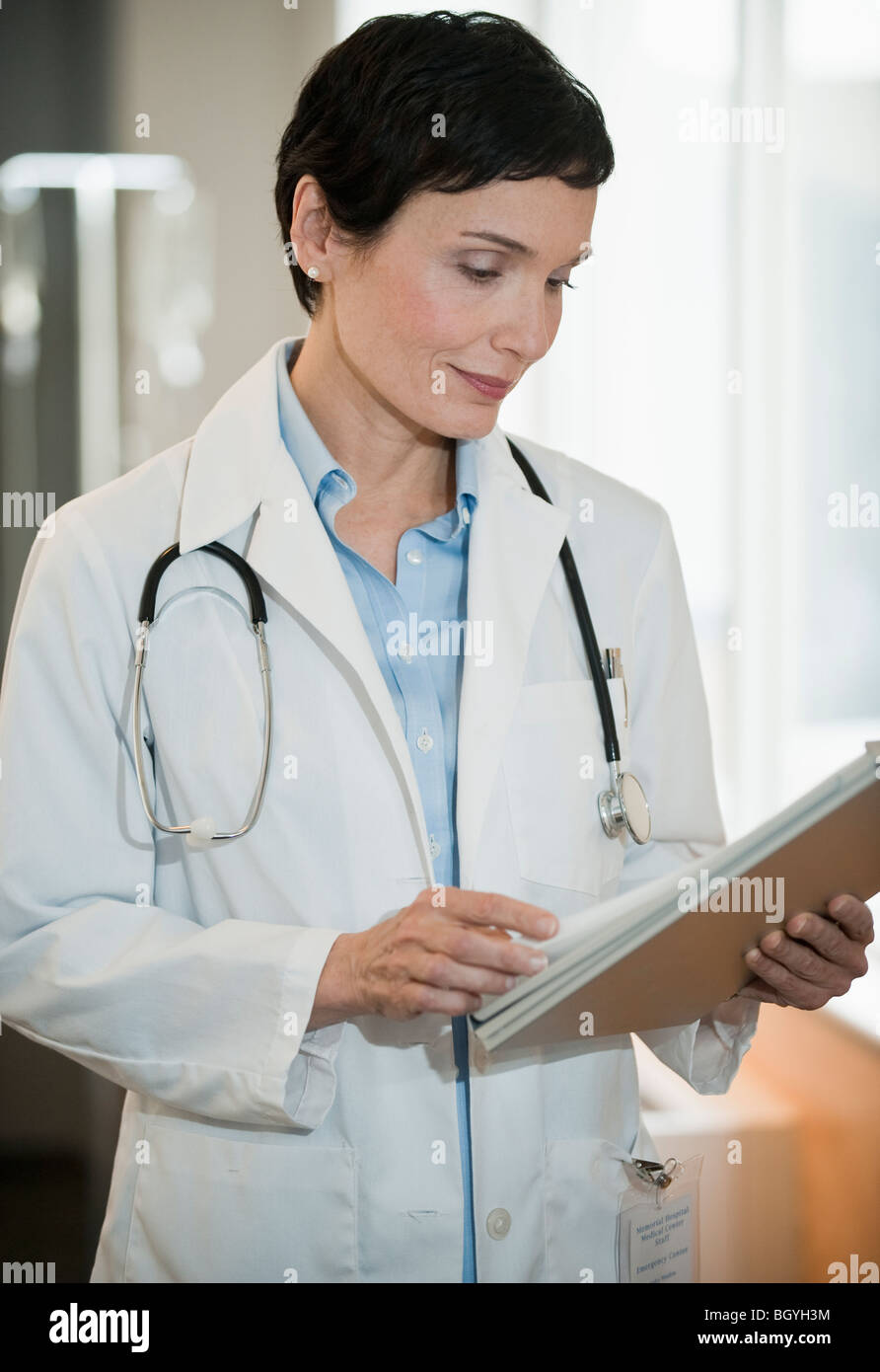 Doctor looking at chart Stock Photo - Alamy