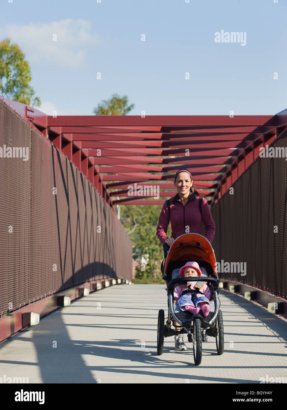 Woman pushing stroller Stock Photo - Alamy