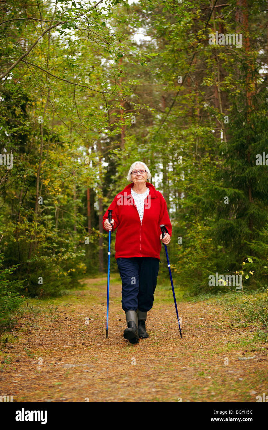Older woman hiking in forest Stock Photo - Alamy