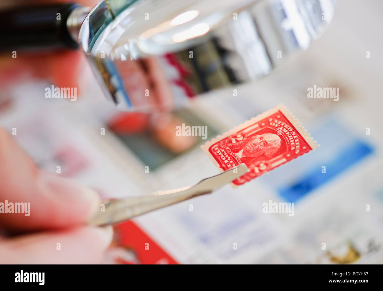 Looking at stamp Stock Photo - Alamy