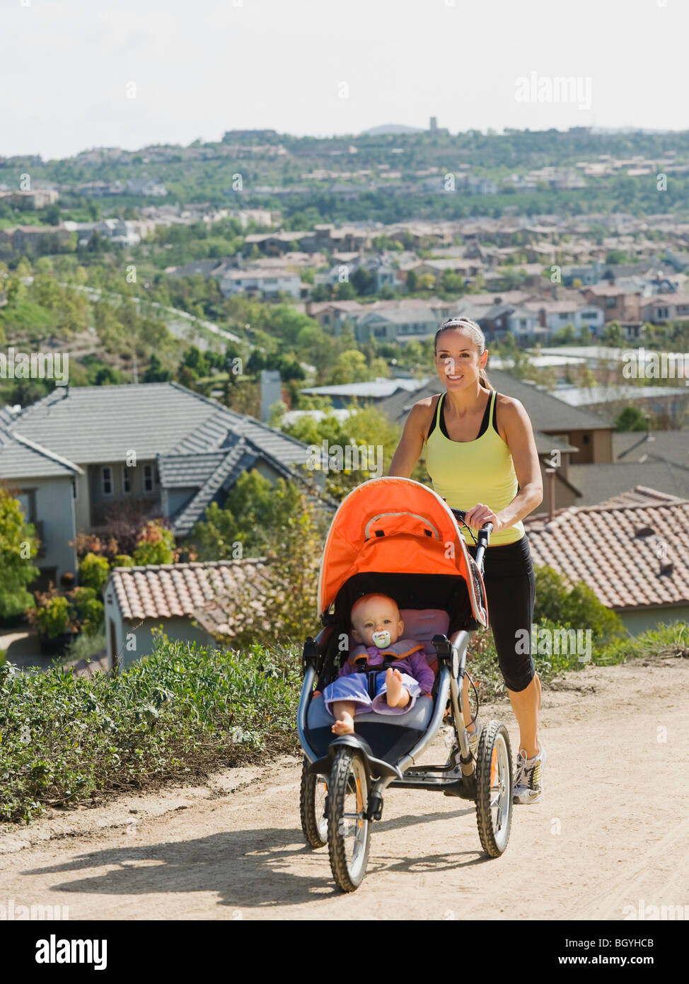 Woman pushing stroller Stock Photo - Alamy