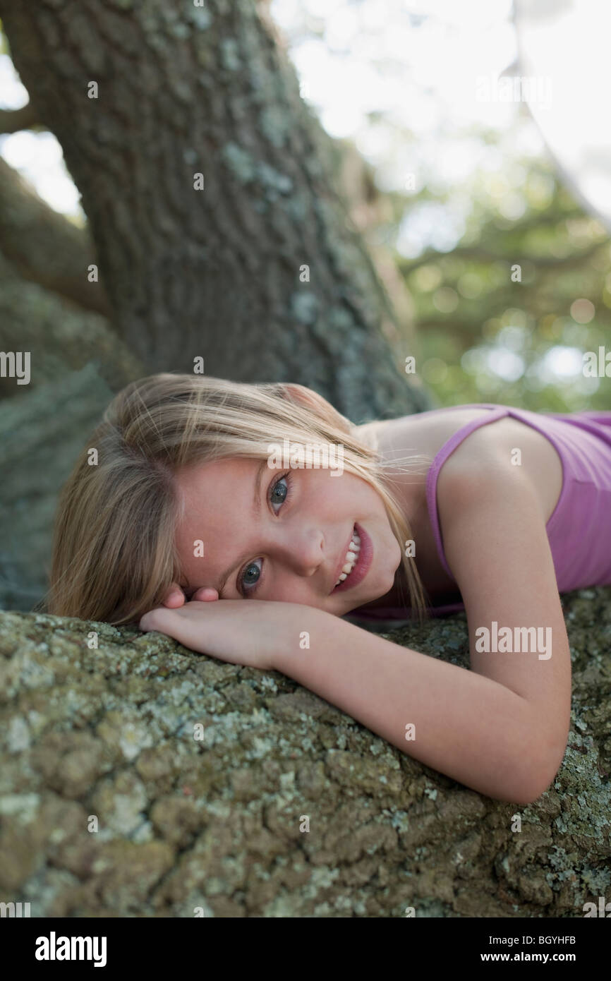 Girl lying on tree branch hi-res stock photography and images - Alamy