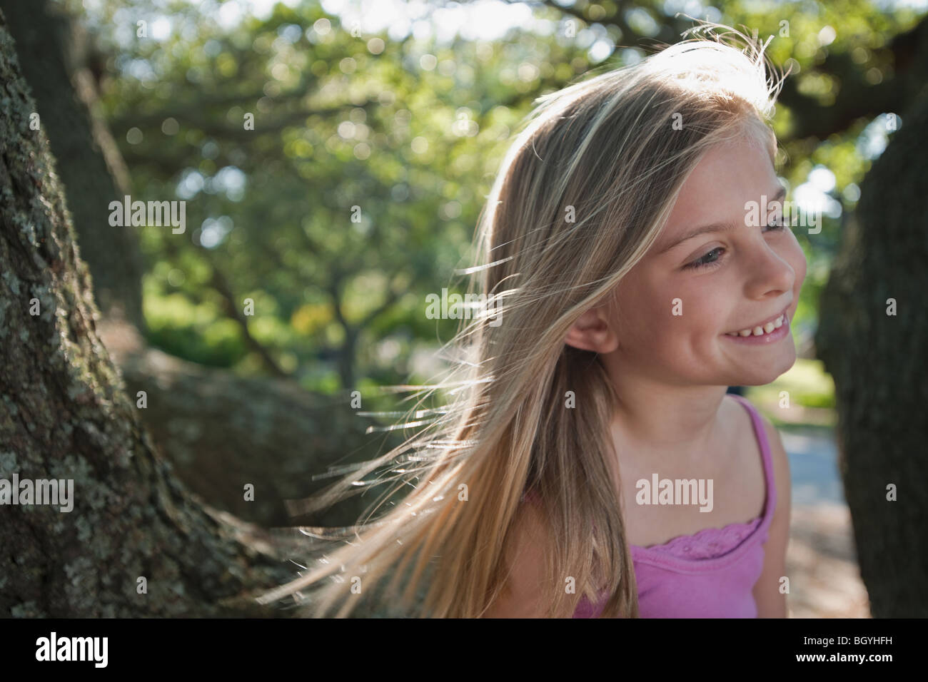 Girl beside tree Stock Photo - Alamy
