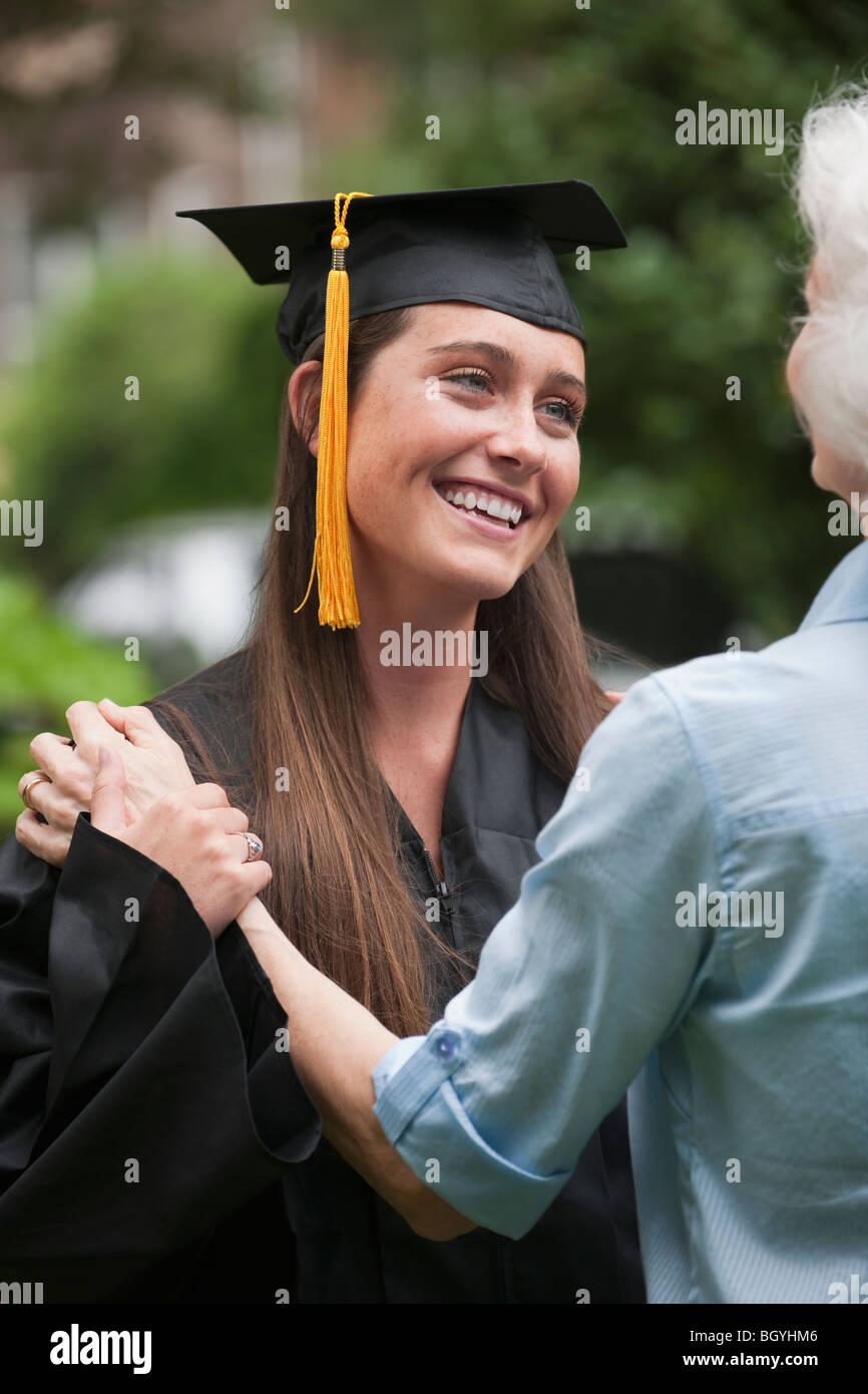 Graduate and elderly woman Stock Photo - Alamy