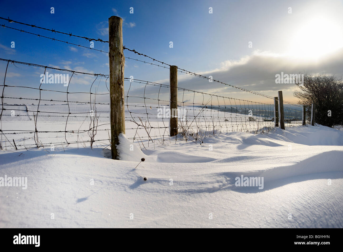 Wooden posts with barbed wire fence in snow hi-res stock photography ...