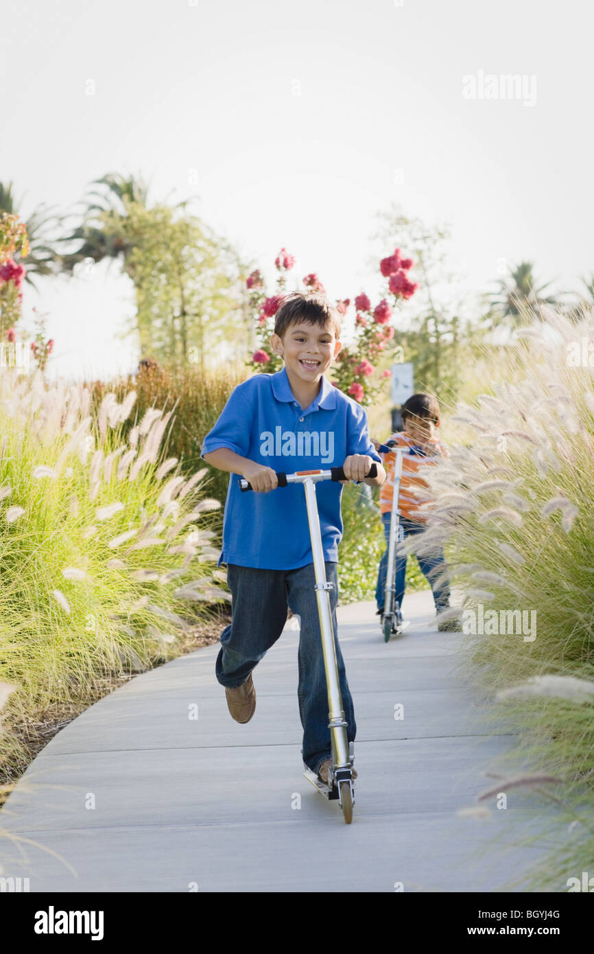 Children riding scooters Stock Photo - Alamy