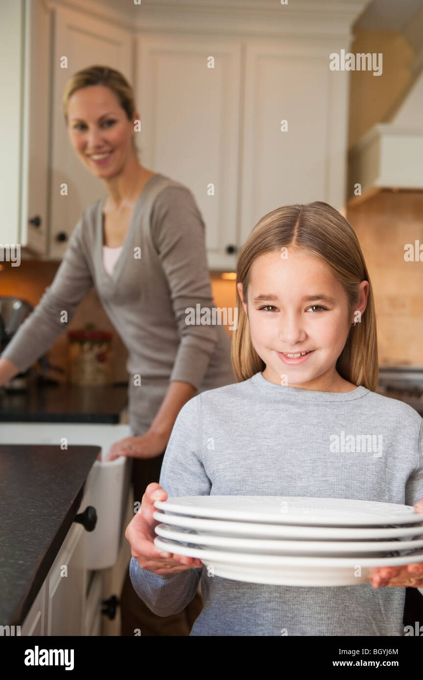 Girl holding plates Stock Photo - Alamy