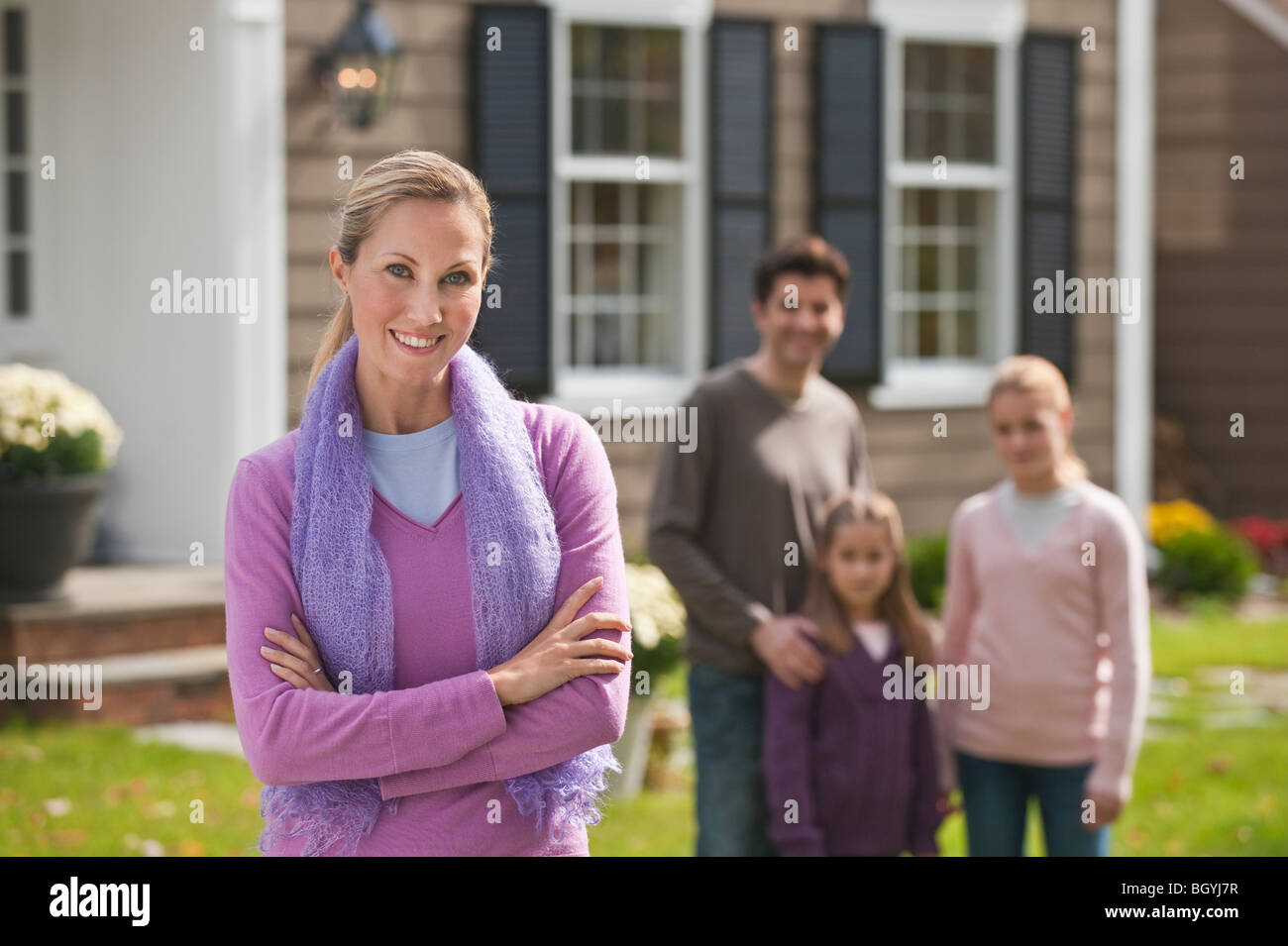 Family in front of house Stock Photo - Alamy