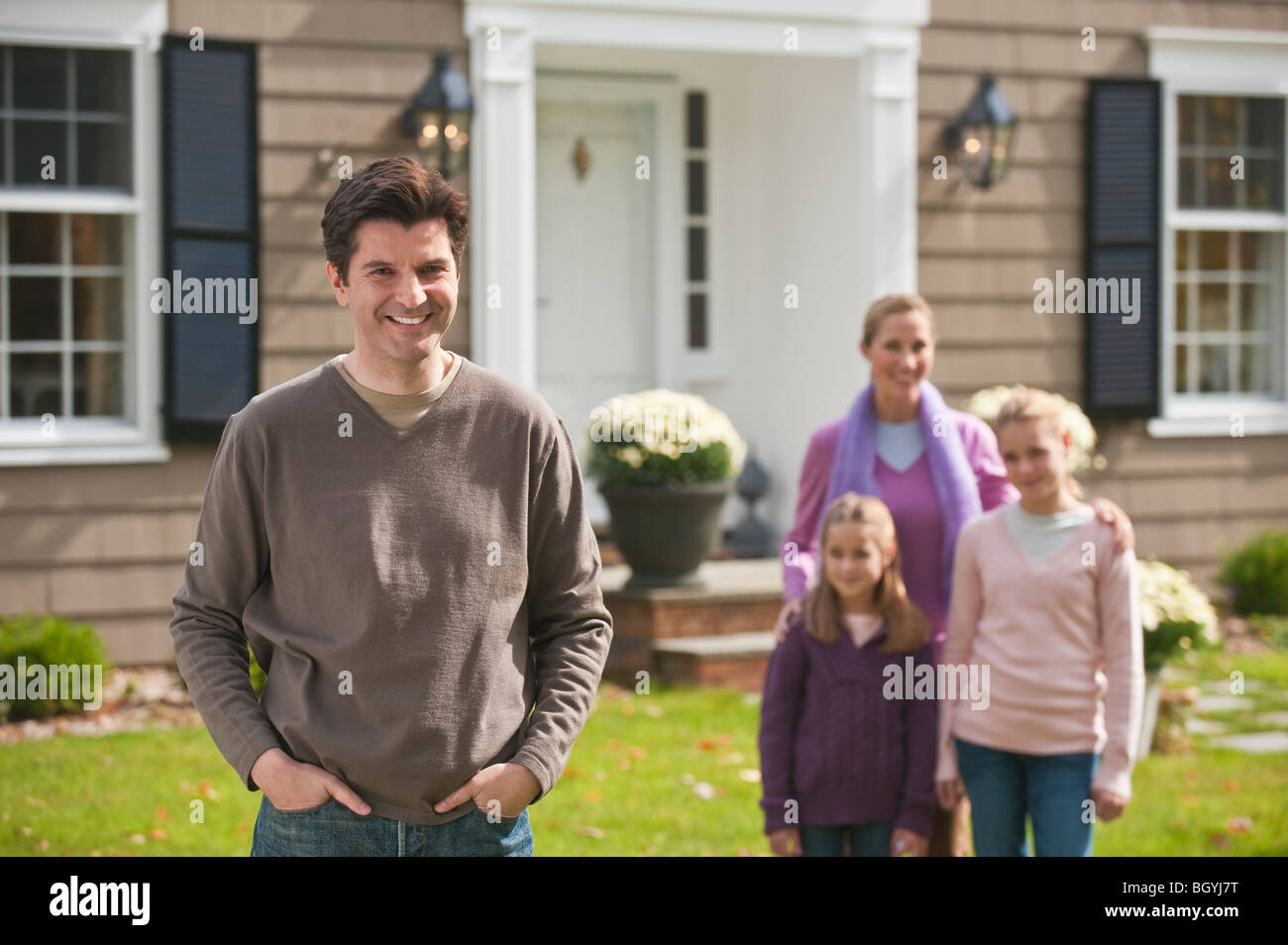 Family in front of house Stock Photo - Alamy