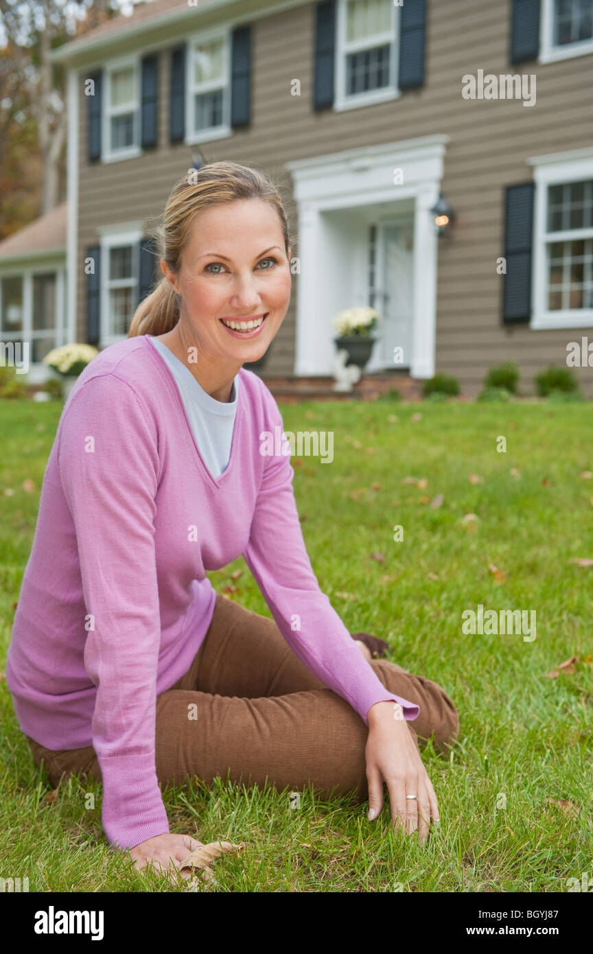Woman in front of house Stock Photo - Alamy