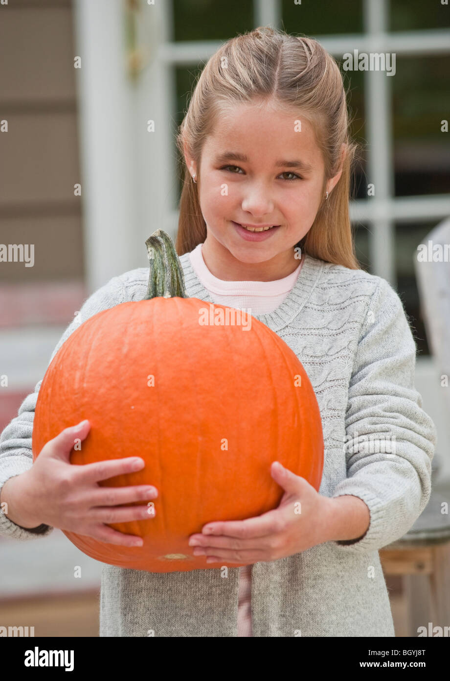 Girl holding pumpkin Stock Photo - Alamy
