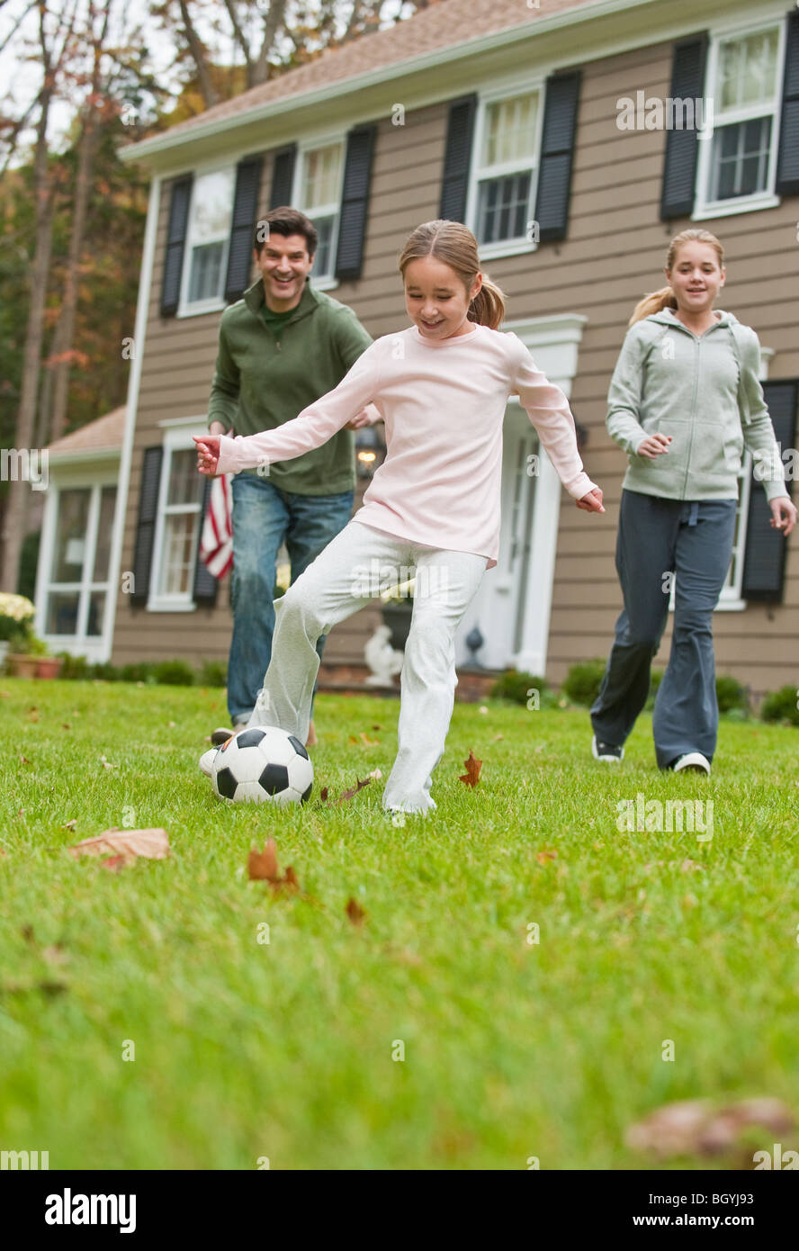 Family playing soccer Stock Photo - Alamy