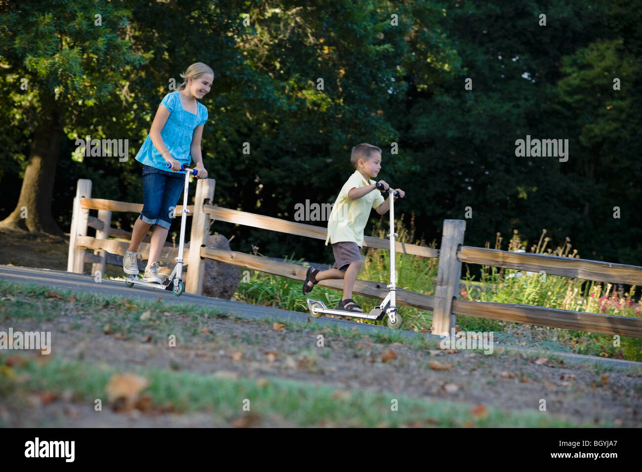 Children riding scooters Stock Photo - Alamy