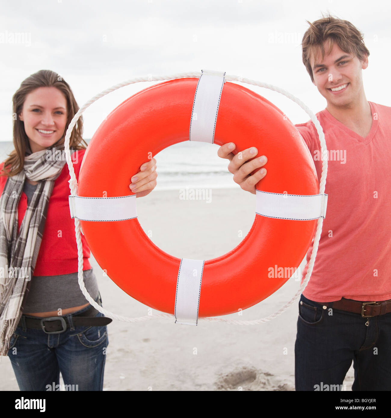 Couple holding life ring Stock Photo - Alamy