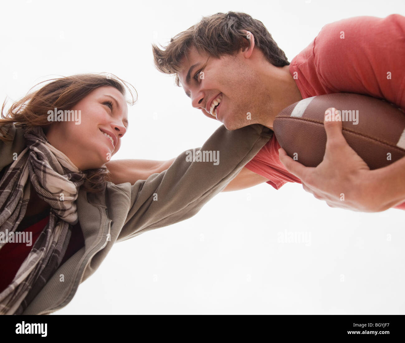 Couple playing football Stock Photo - Alamy