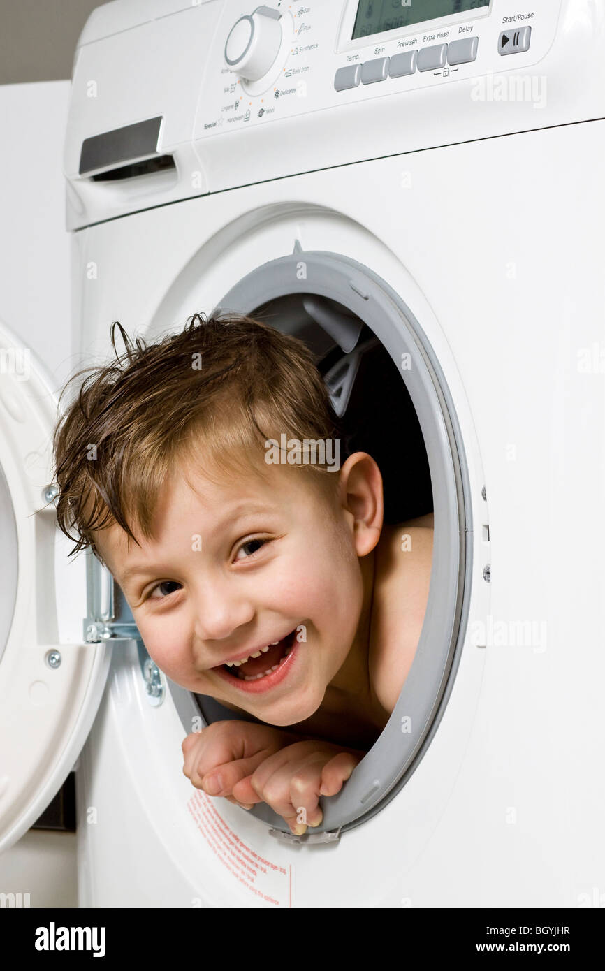 Boy have fun in washing machine Stock Photo - Alamy