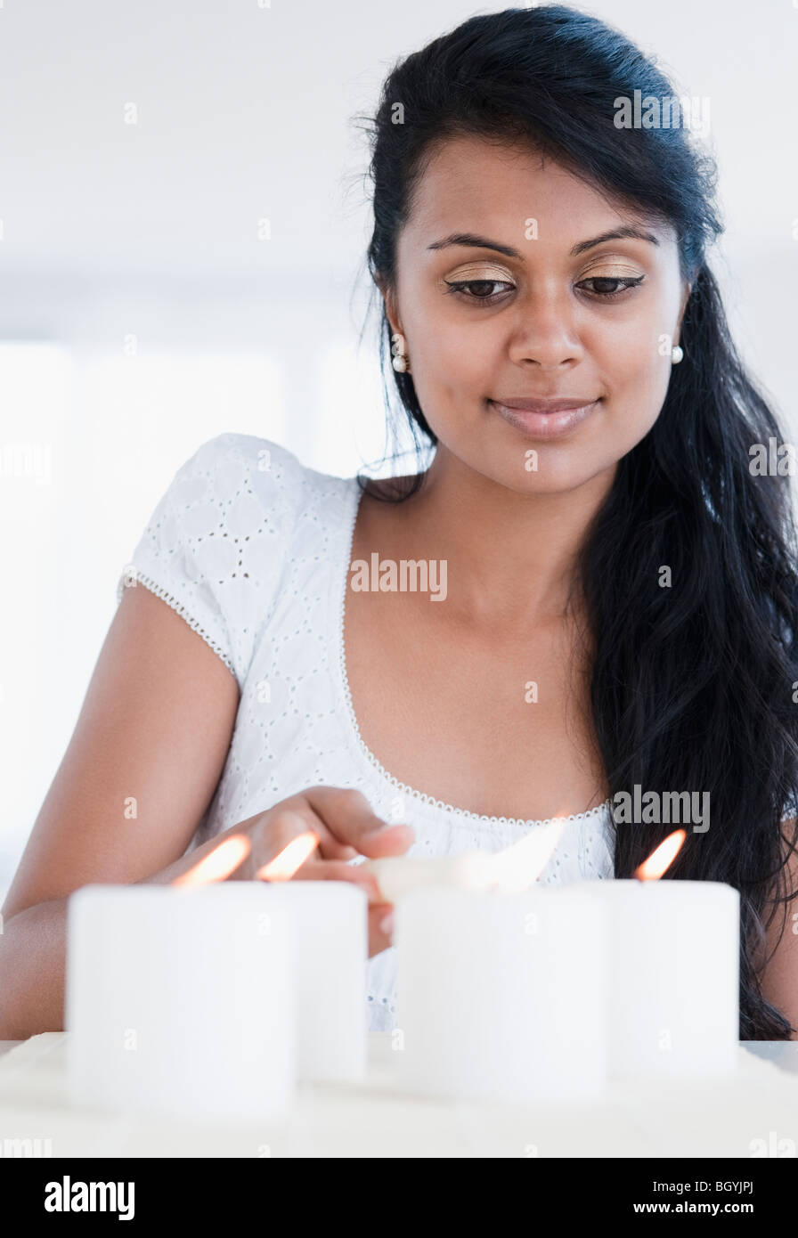 Mid adult woman lighting candle hi-res stock photography and images - Alamy
