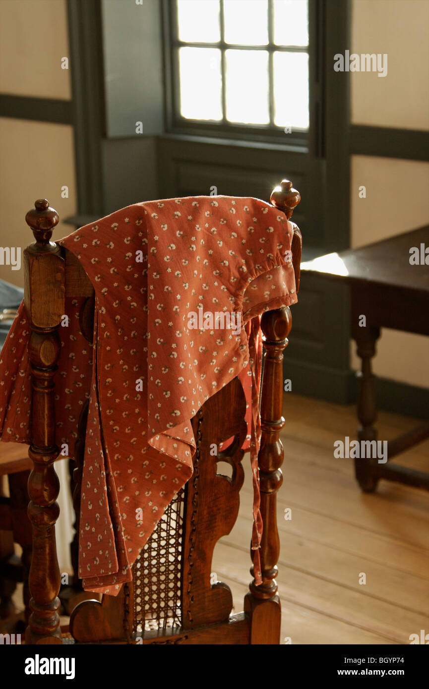 A chair and an apron in the afternoon light Stock Photo - Alamy