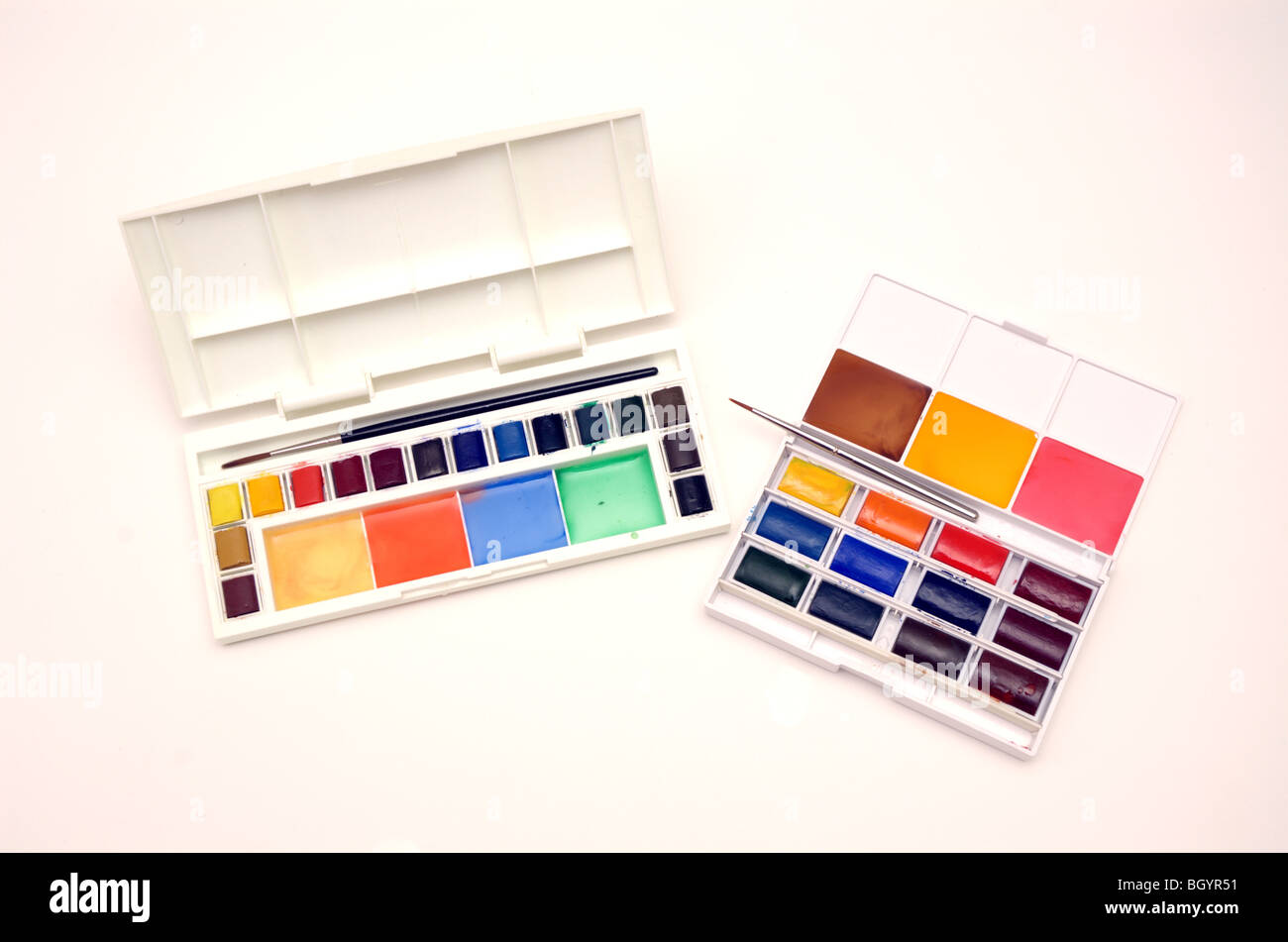 Two boxes of watercolour pan paints with some colours mixed for use ...