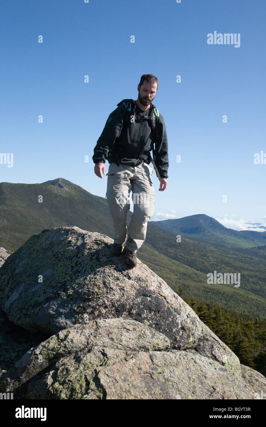 A hiker on the summit of Mount Liberty during the summer months ...