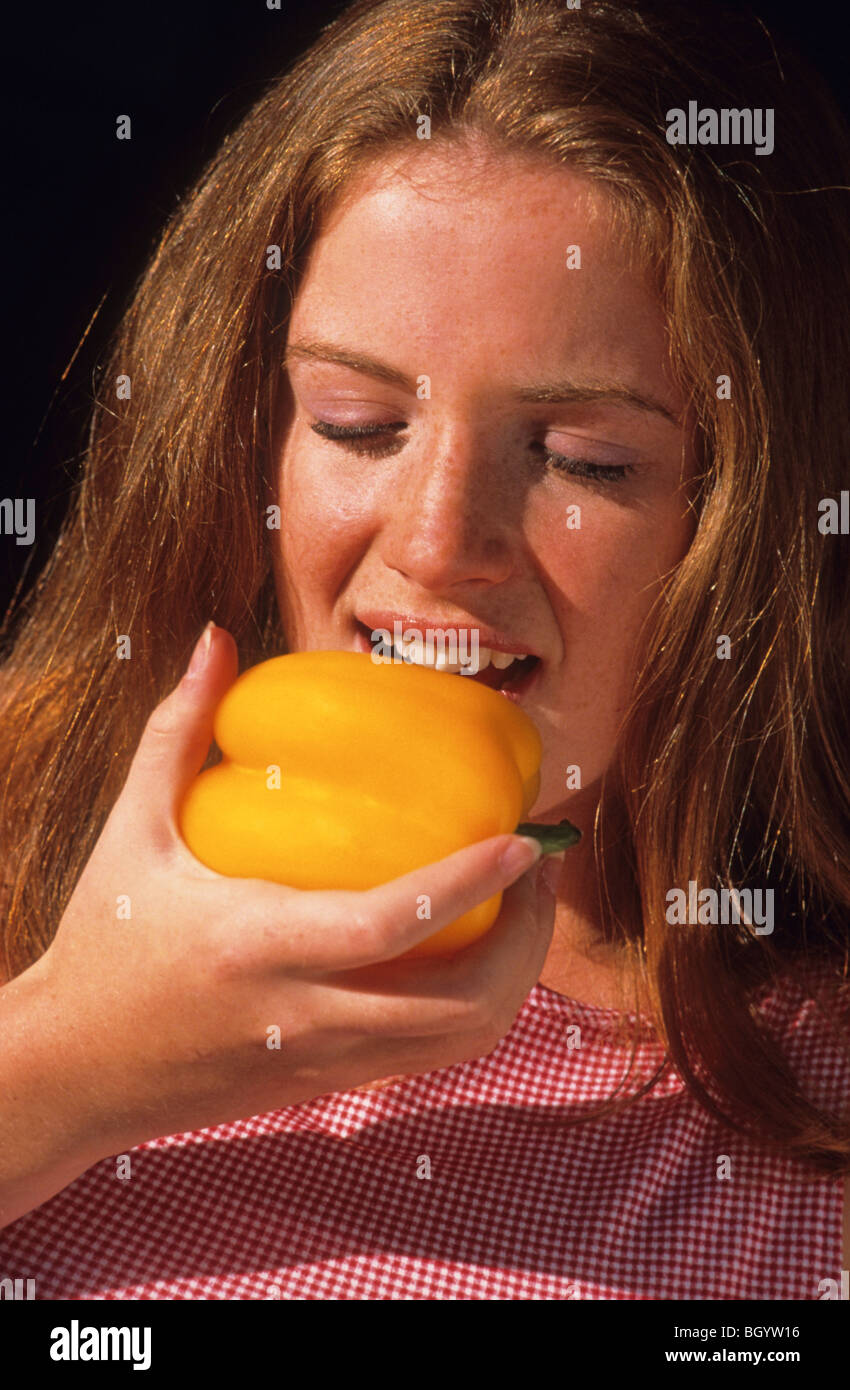 Woman eating pepper Stock Photo - Alamy
