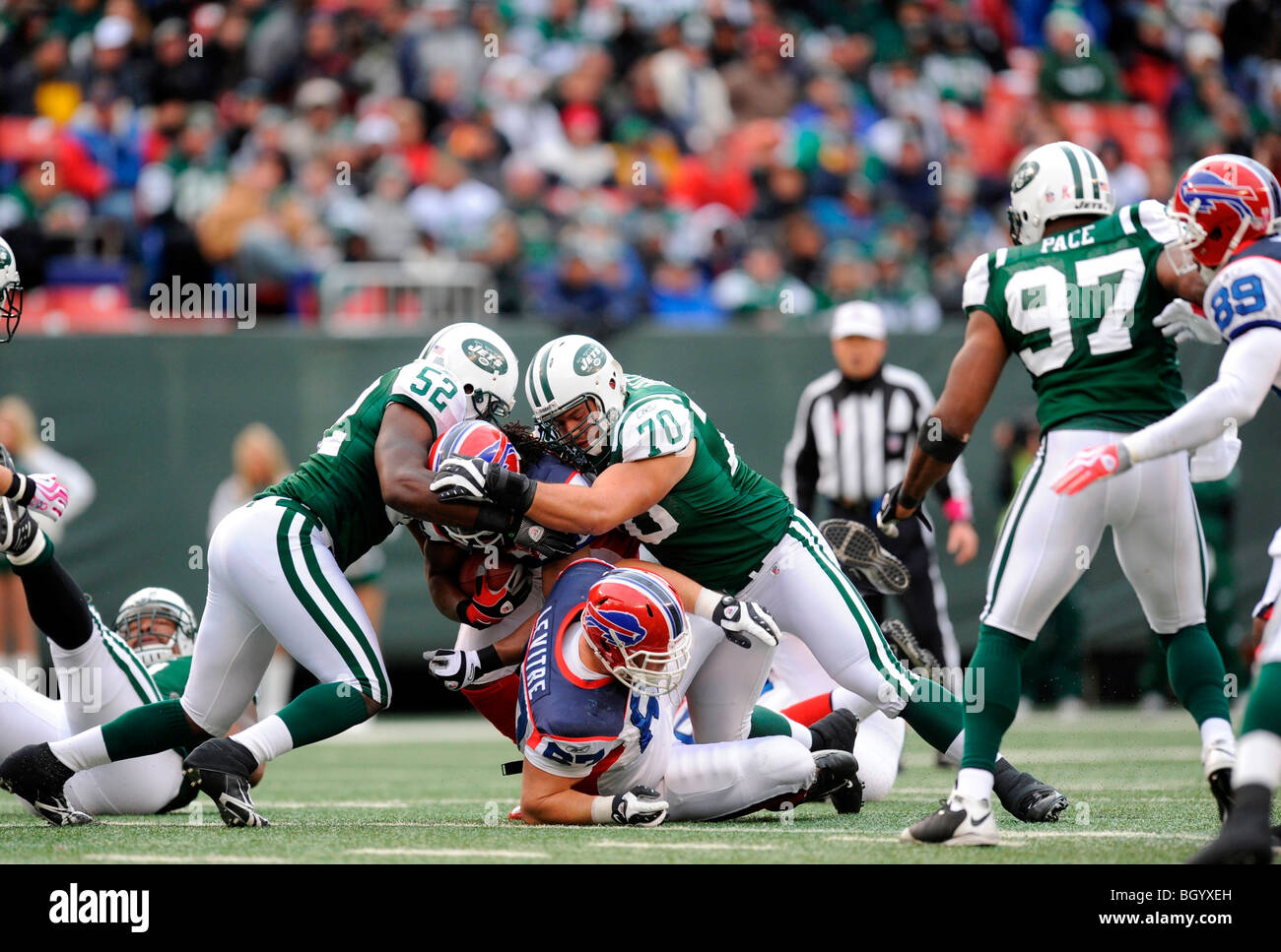 David Harris #52 and Mike Devito #70 of the New York Jets make a tackle ...