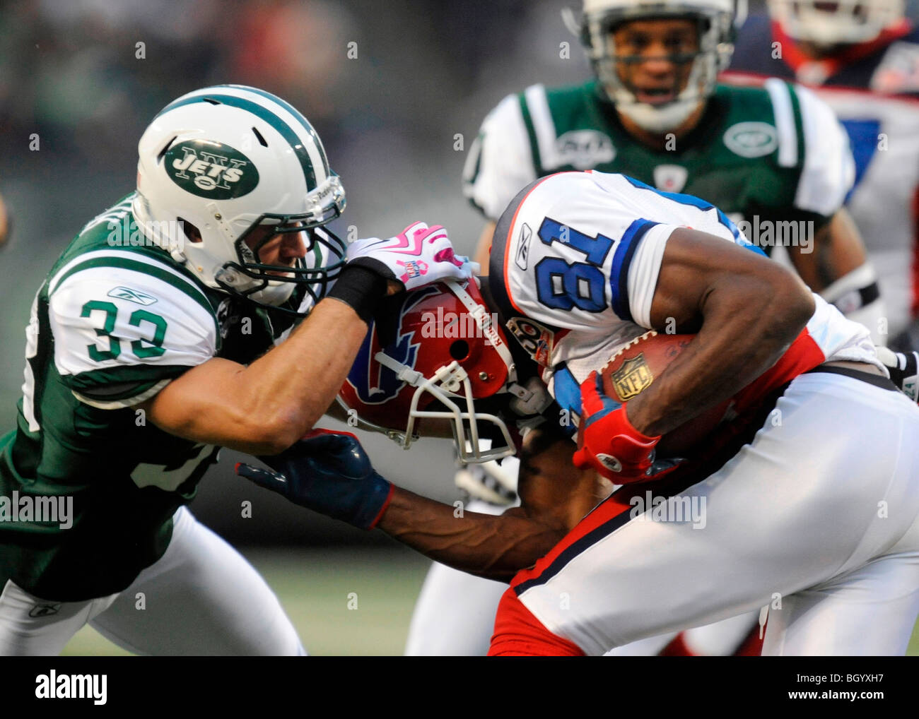 Eric Smith #33 of the New York Jets tackles Terrell Owens #81of the ...