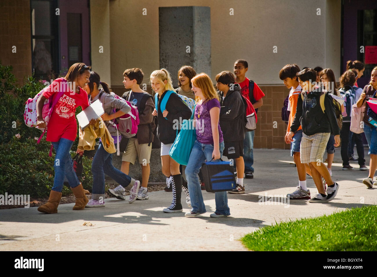 A multi-ethnic group of California middle school students cross their ...